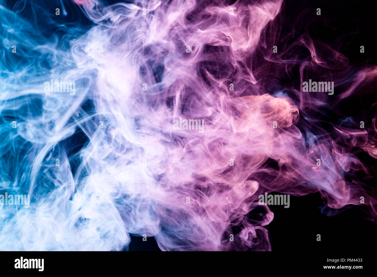 Thick colorful smoke of red, pink and blue on a black isolated ...