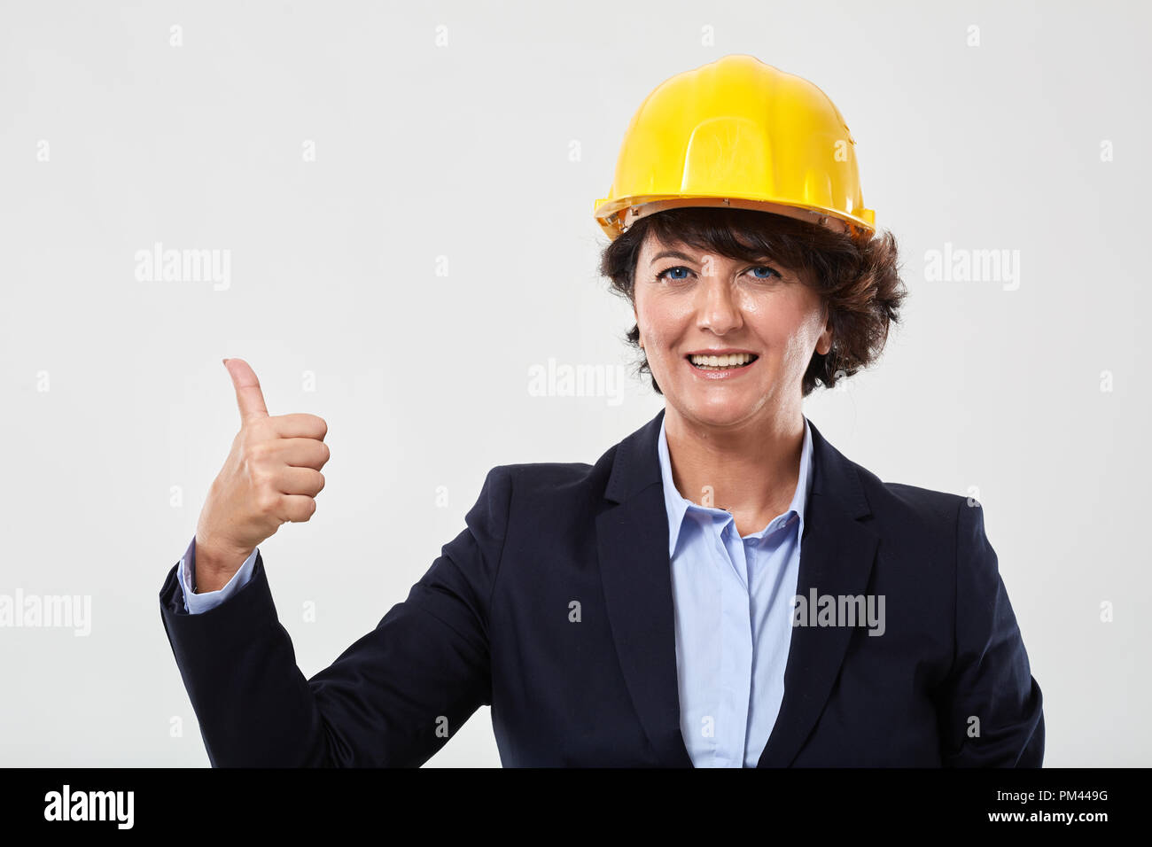 Middle aged construction engineer woman showing thumbs up sign Stock ...