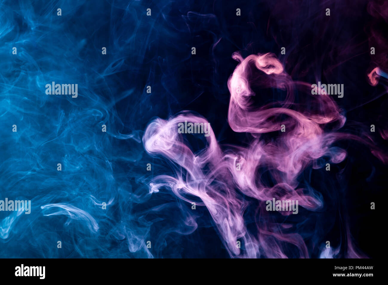 Thick colorful smoke of red, pink and blue on a black isolated ...