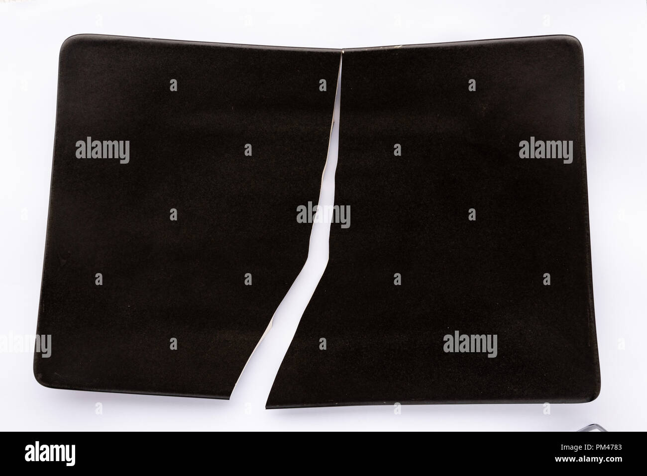 Cracked black ceramic plate Stock Photo - Alamy