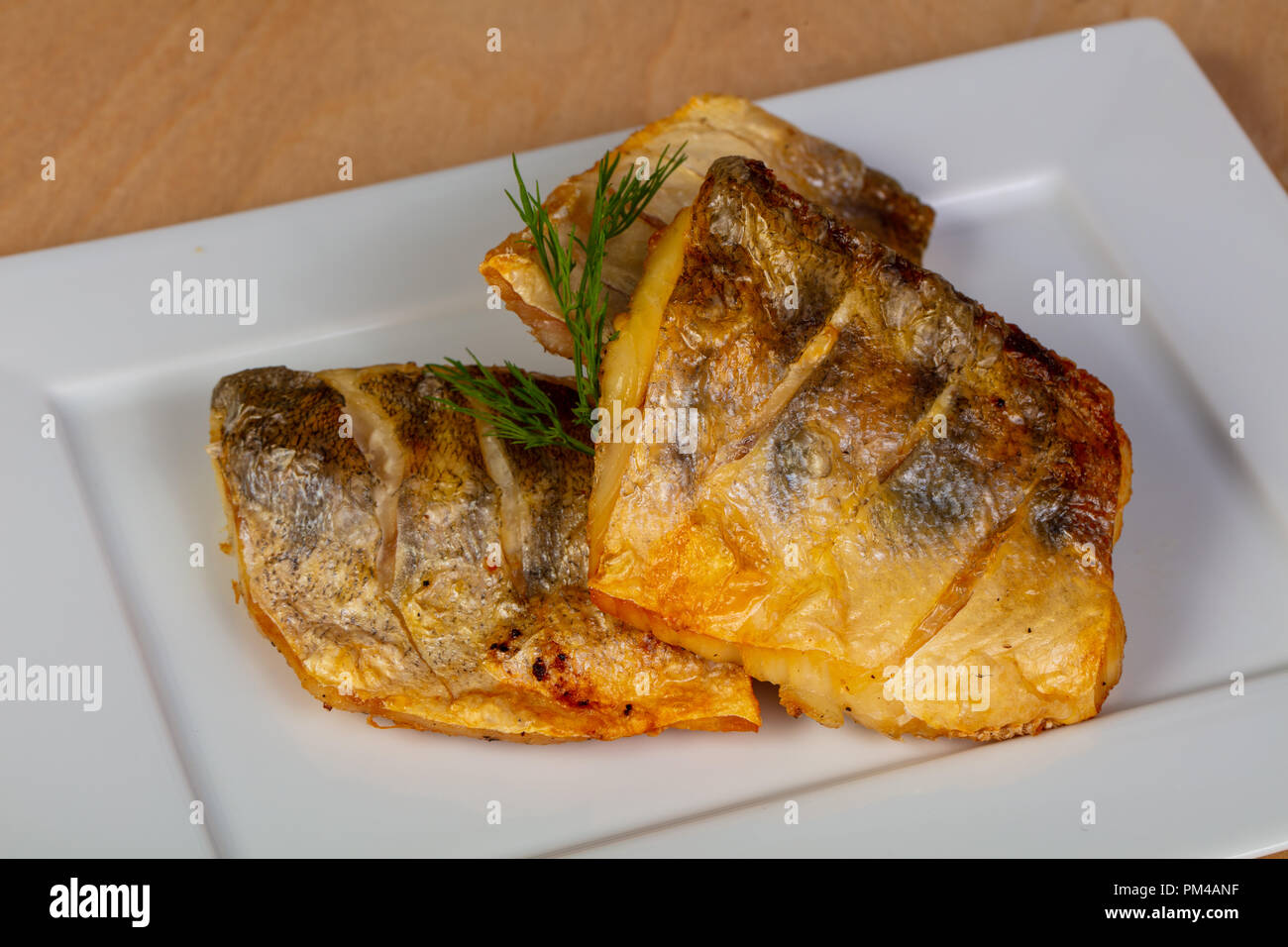 Roasted pike perch in the plate Stock Photo - Alamy