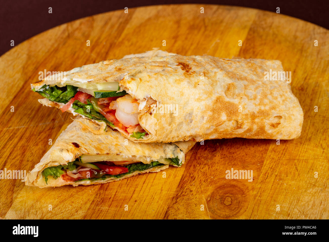 Wrap tortilla with prawn and vegetables Stock Photo - Alamy