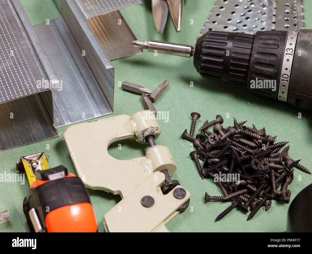 Plasterboard tools set with metal studs, screws, tape measure, rasp ...