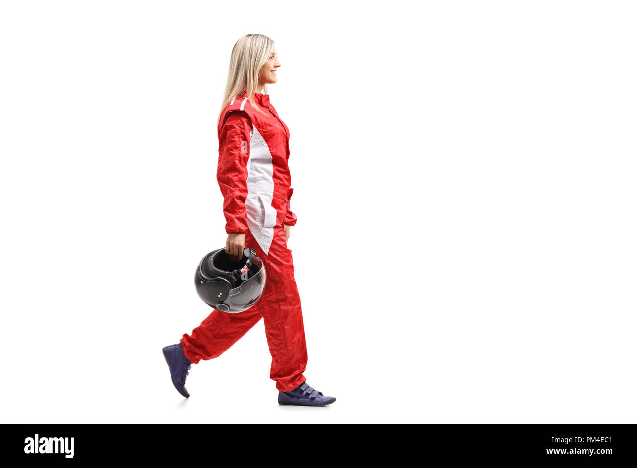 Female racer walking and holding a helmet isolated on white background ...