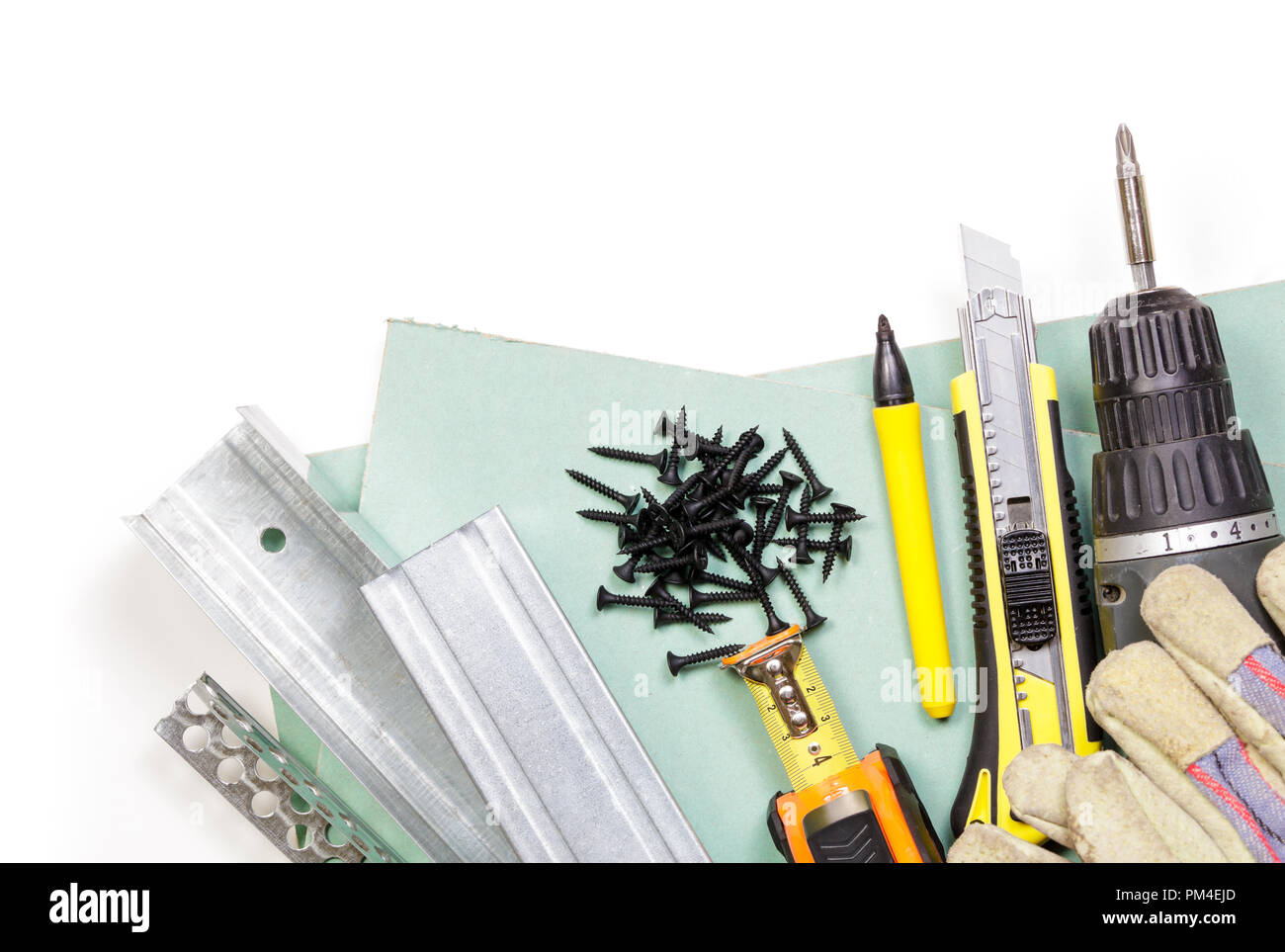 Plasterboard, tools, metal studs, screws, and protective gloves on ...