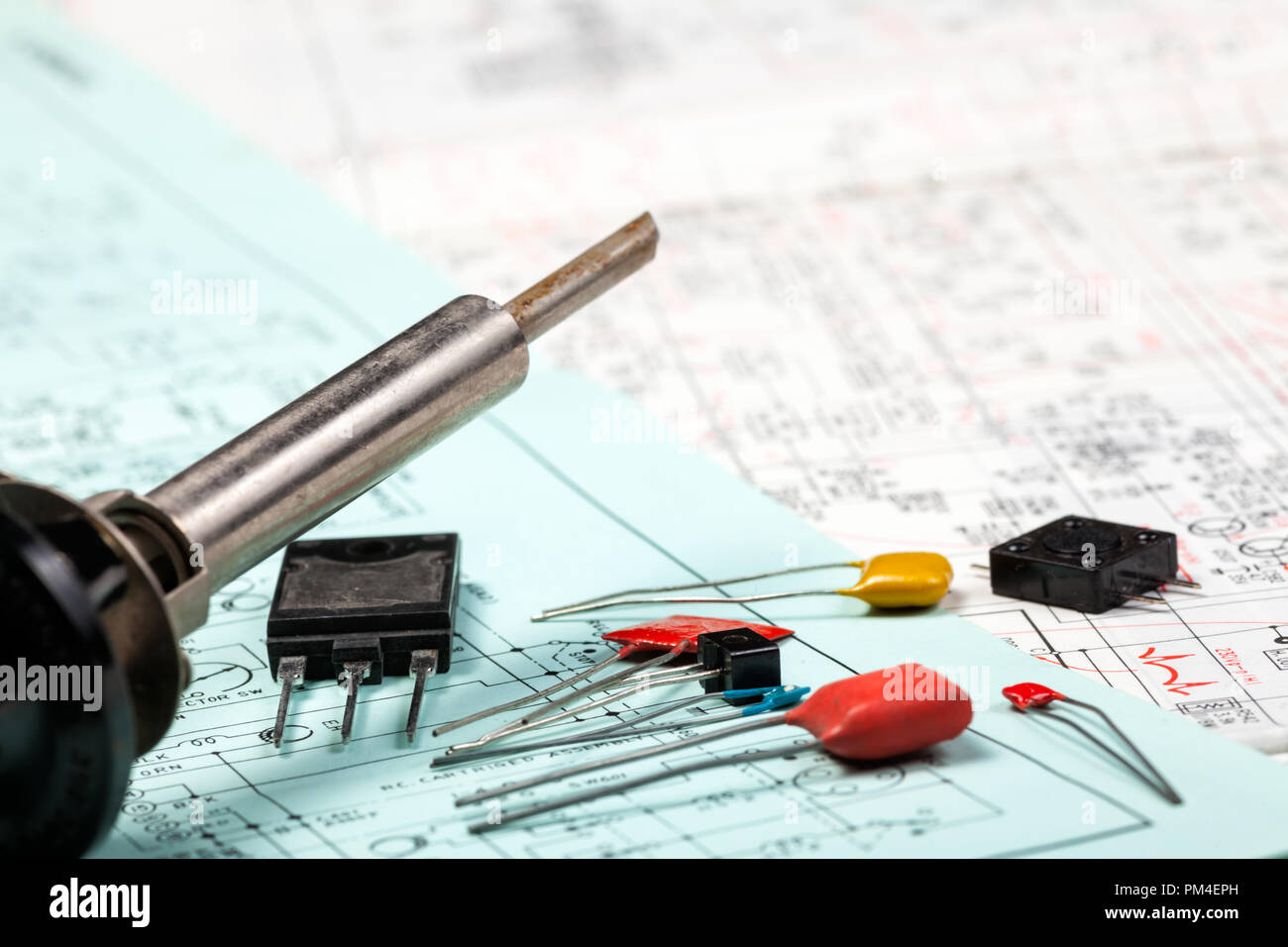Soldering iron with electronic components on electric schemes Stock ...
