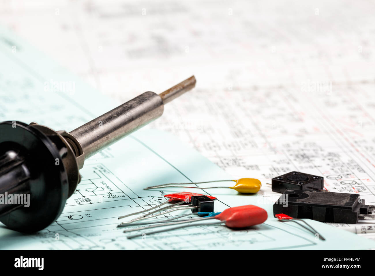 Soldering iron with electronic components on electric schemes Stock ...