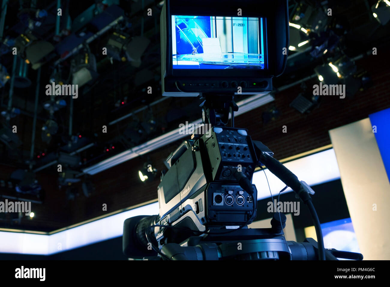 Television studio with camera and lights - recording TV show. Shallow ...