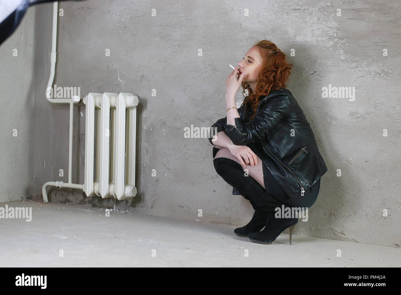 Girl addict in a leather jacket with a dose in a syringe prostitute ...