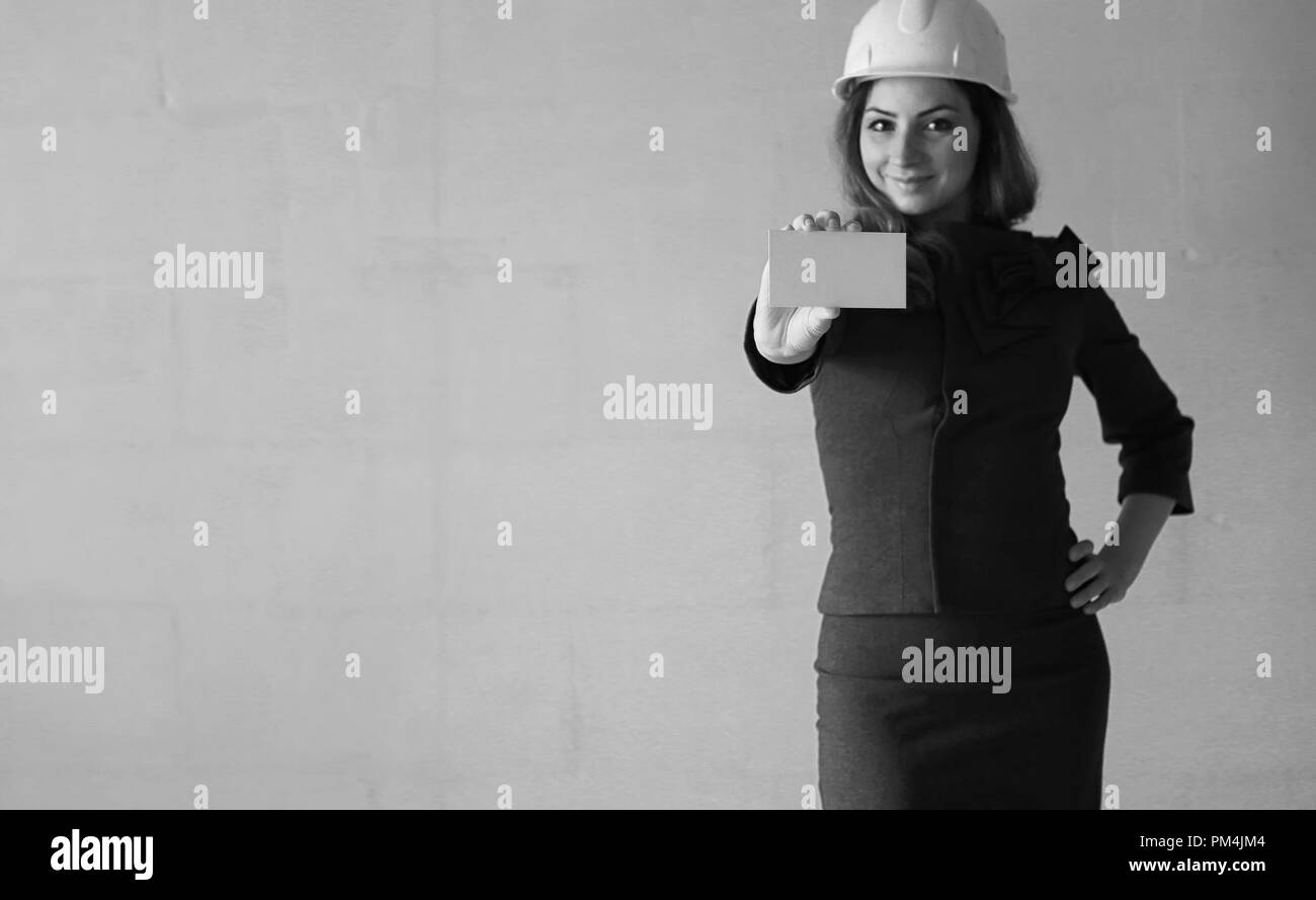 Girl With A Blank Sheet Of Paper In His Hand On Construction Sit Stock girl-with-a-blank-sheet-of-paper-in-his-hand-on-construction-sit-stock