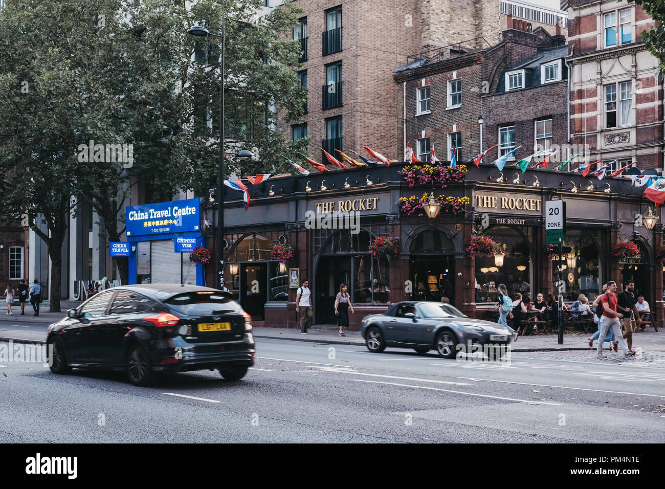 London, UK - July 26, 2018: People and cars in front of The Rocket pub ...