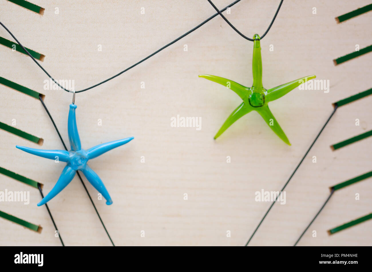 Two star necklaces on white background Stock Photo - Alamy