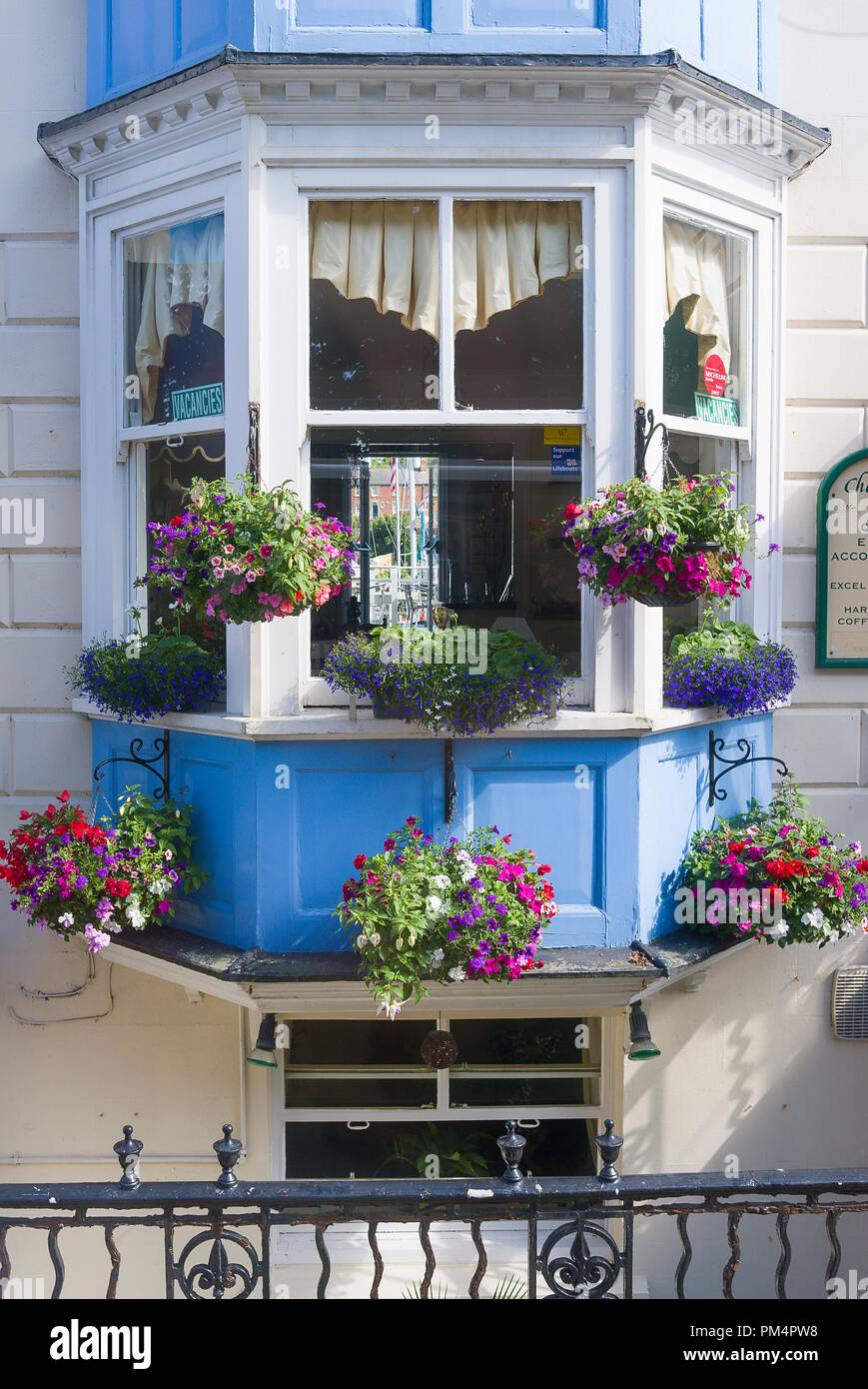 Period bay window with floral decoration at a small hotel in Weymouth ...
