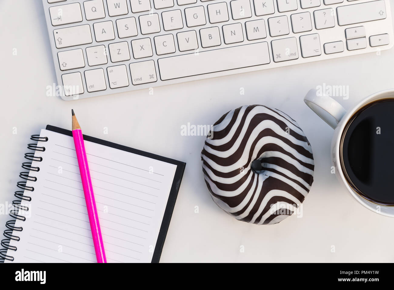 Computer keyboard notebook coffee donut on white background Stock Photo ...