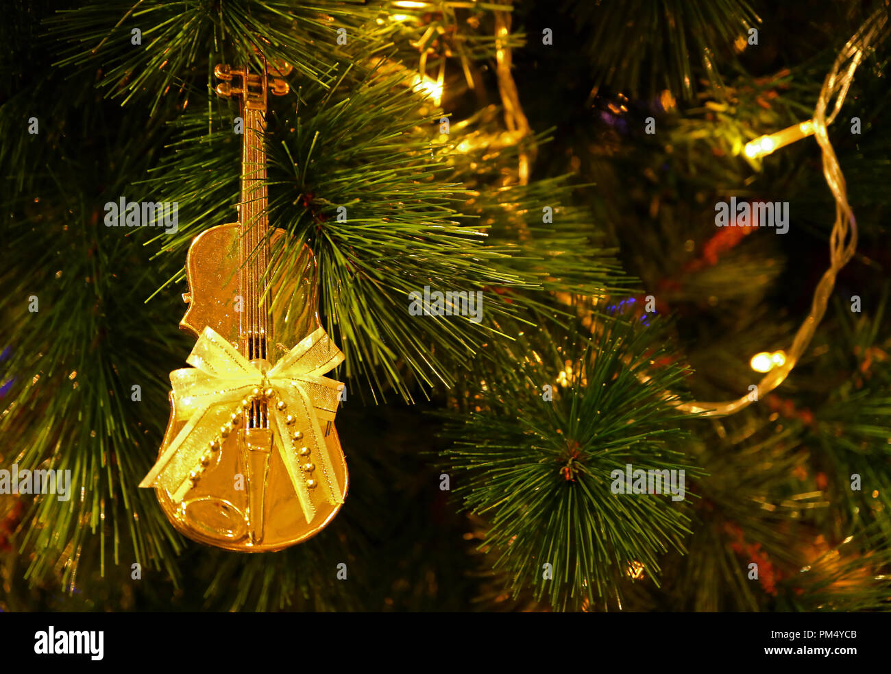 Shiny Gold Cello Shaped with Ribbon Bow Christmas Ornament Hanging on ...