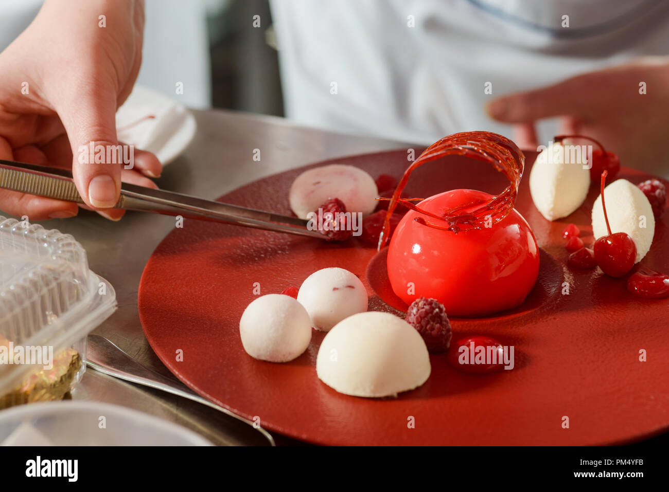 Decorating dessert with raspberries Stock Photo - Alamy