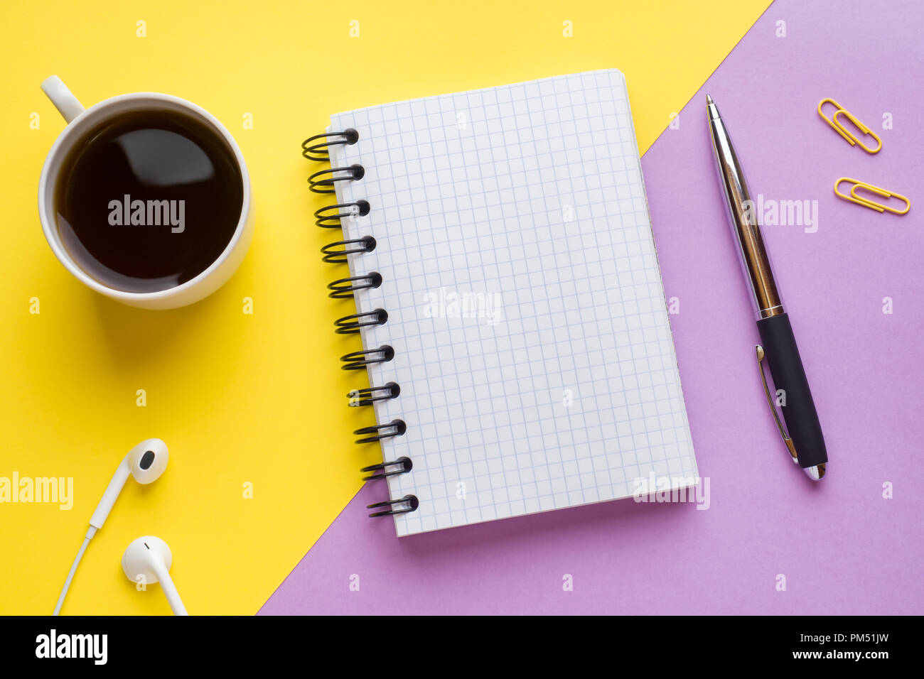 Notepad for text and a Cup of coffee yellow and pink table with copy ...