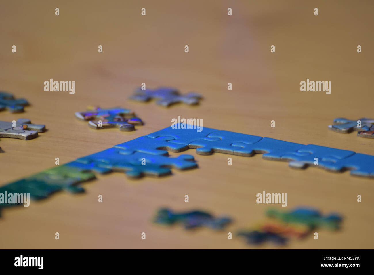 The edge pieces of a jigsaw puzzle being made Stock Photo - Alamy