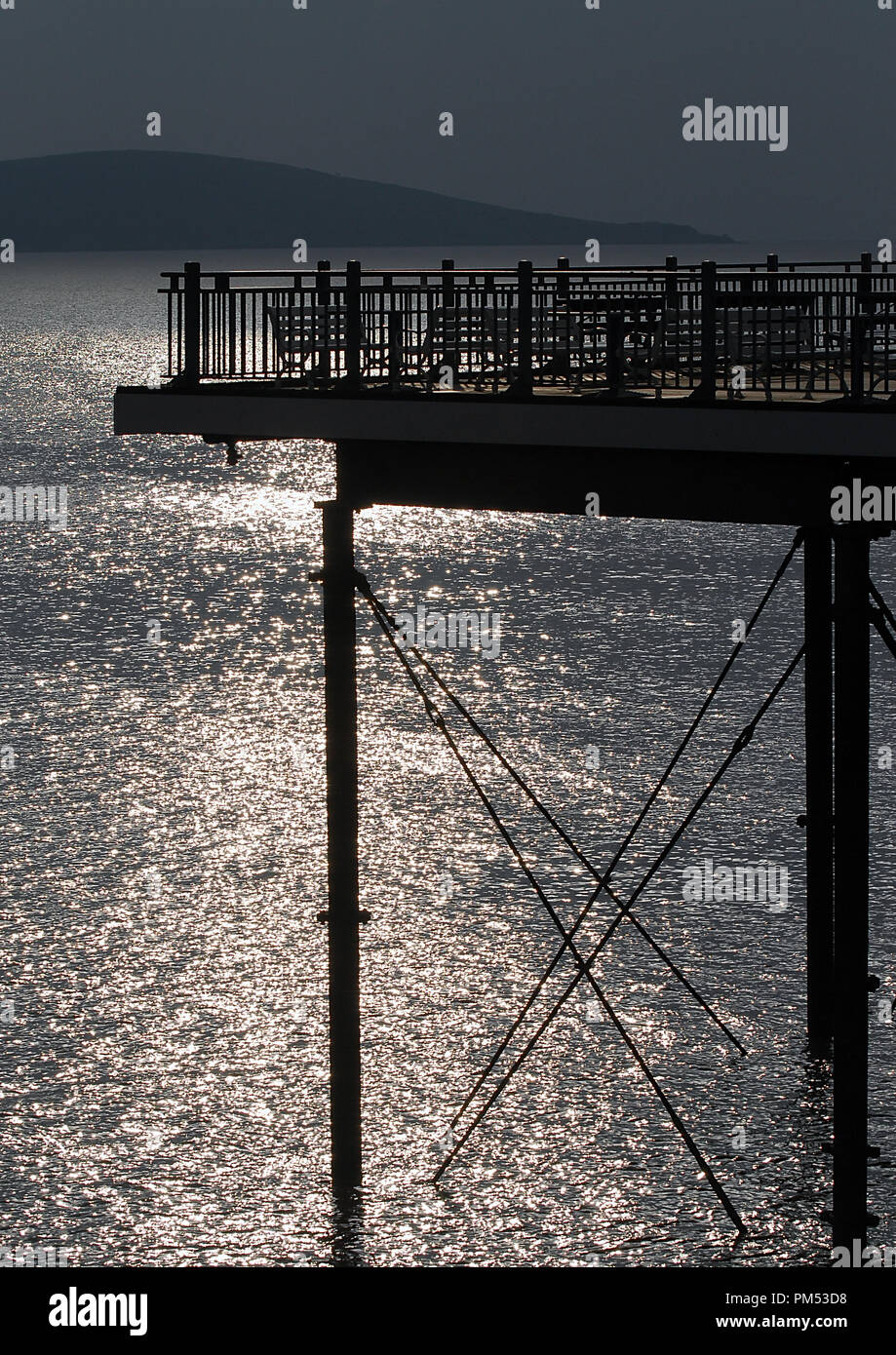 A pier backlit by reflected sunlight Stock Photo - Alamy