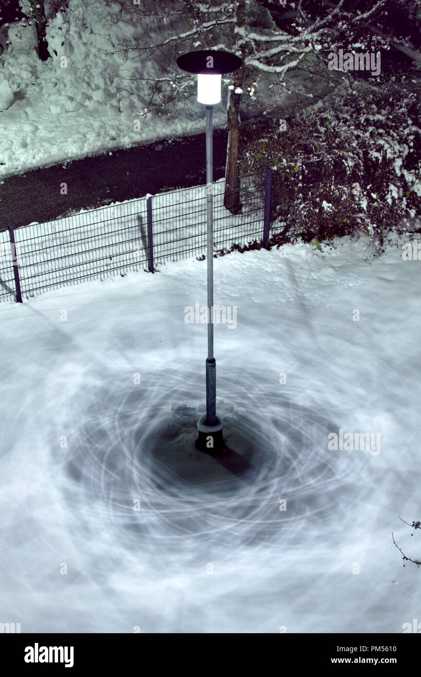 Modern led streetlight drawing an odd light pattern to the snow. Saving ...