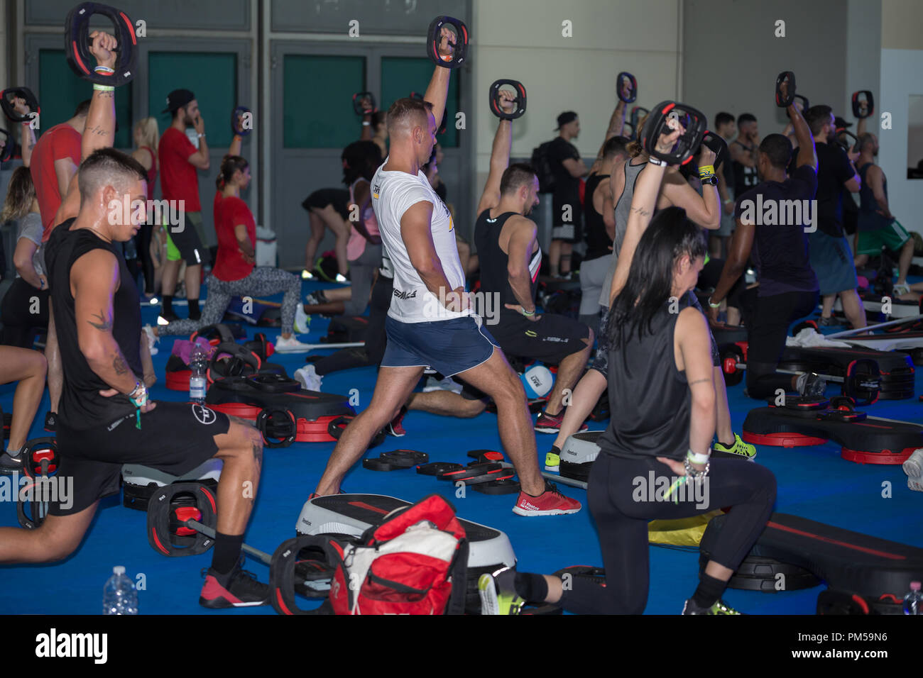 Fitness Workout in Gym: People doing Exercises in Class with Step ...