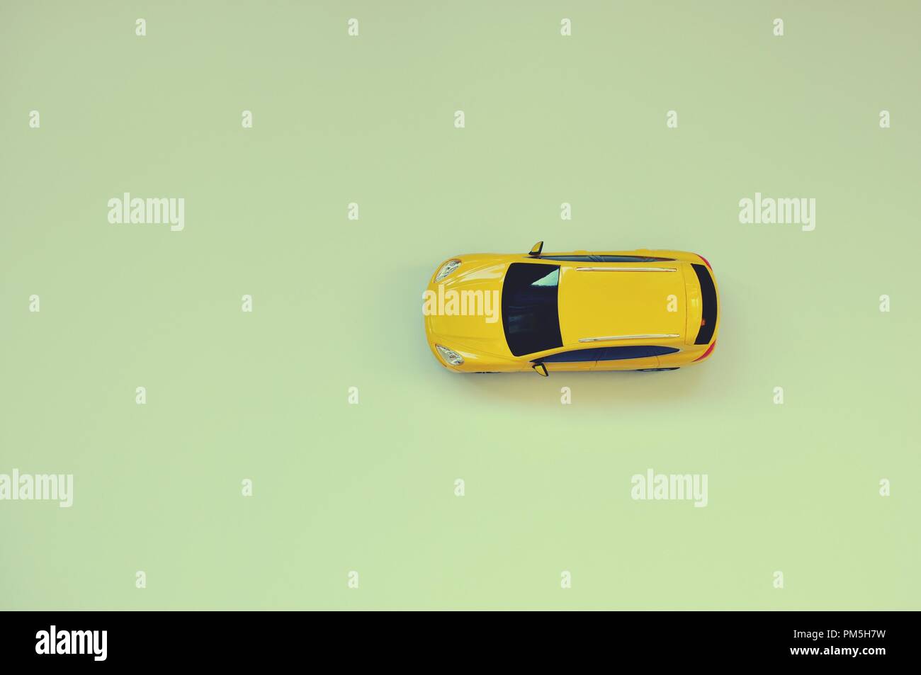 Toy yellow car on green background. Retro style, top view Stock Photo ...