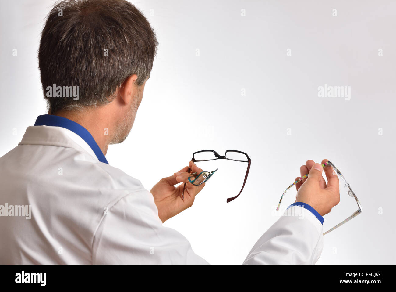 Optician on his back showing glasses. Concept of visual correction with ...