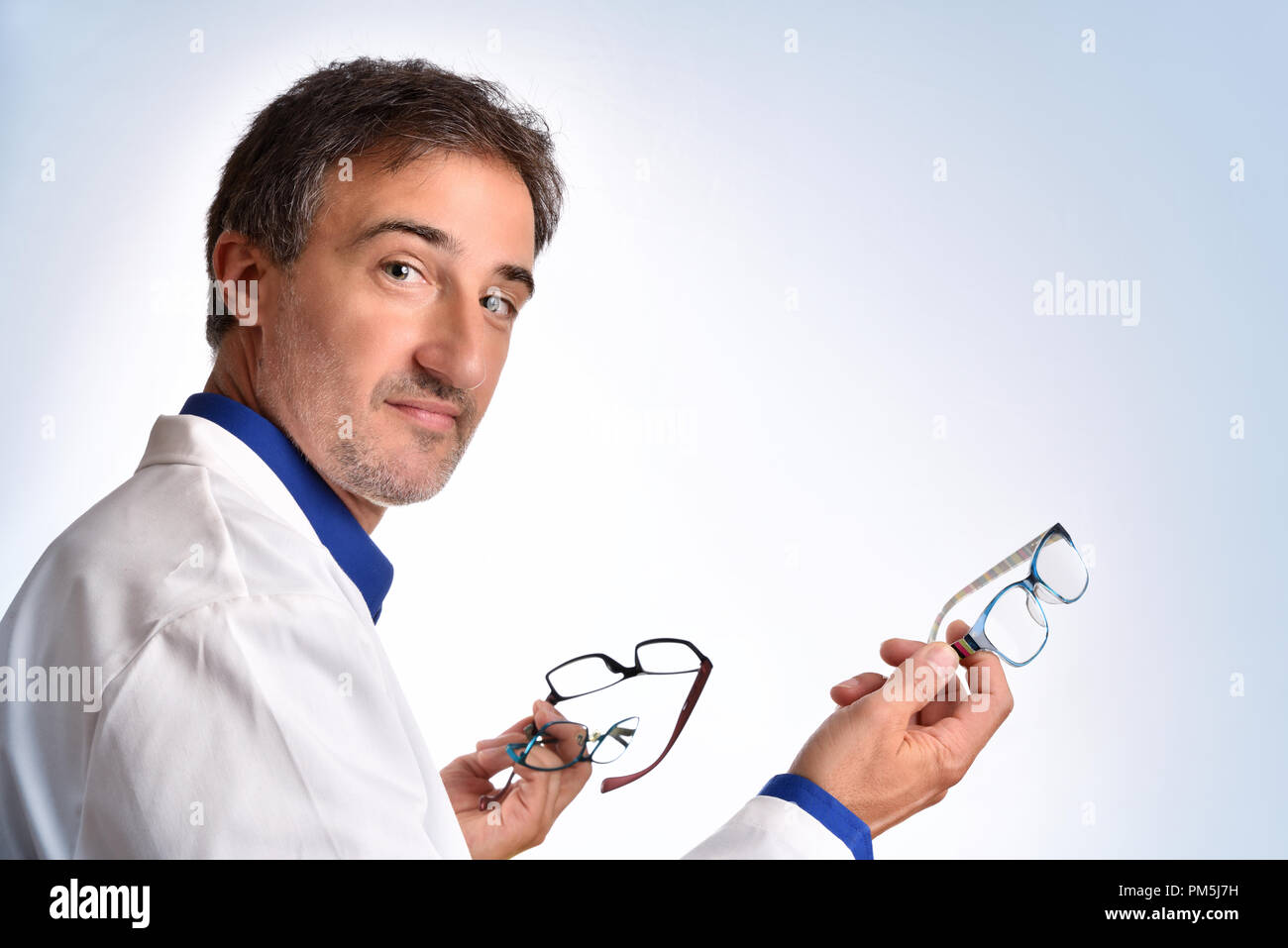 Portrait of an optician with glasses in the hands. Concept of visual ...