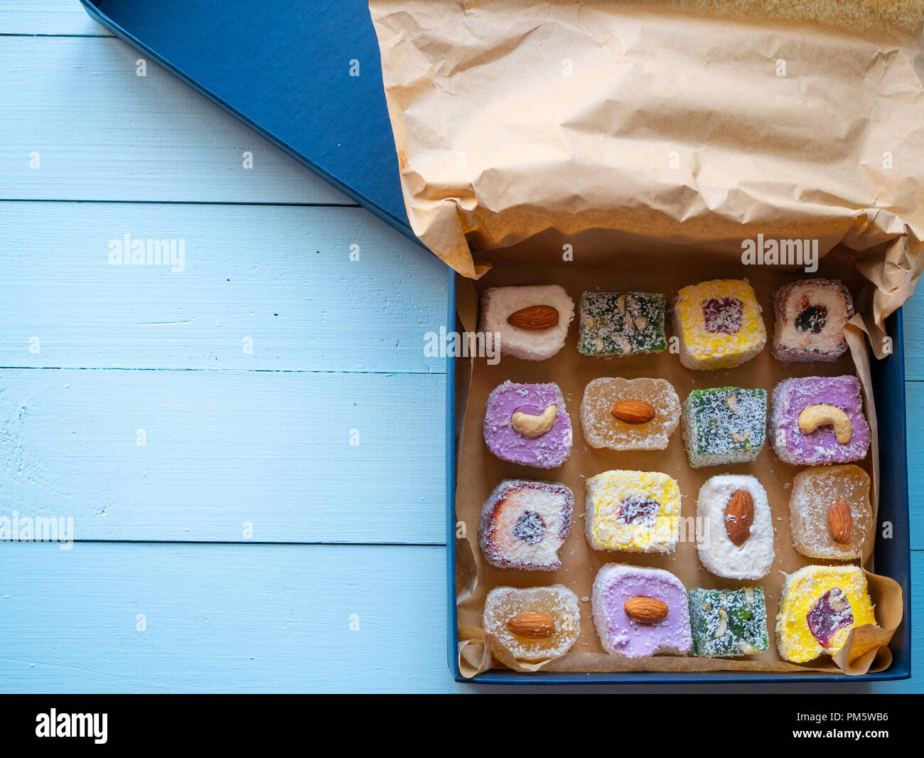 opened box of assorted delicious candys turkish delight on wooden ...