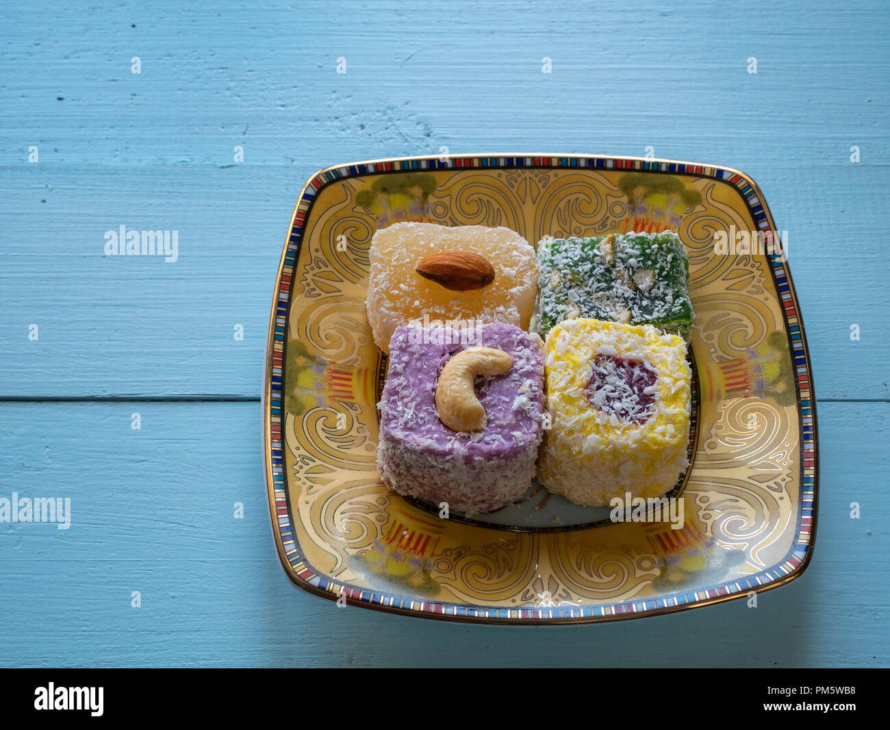four different pieces of turkish delight on authentic arabic plate ...