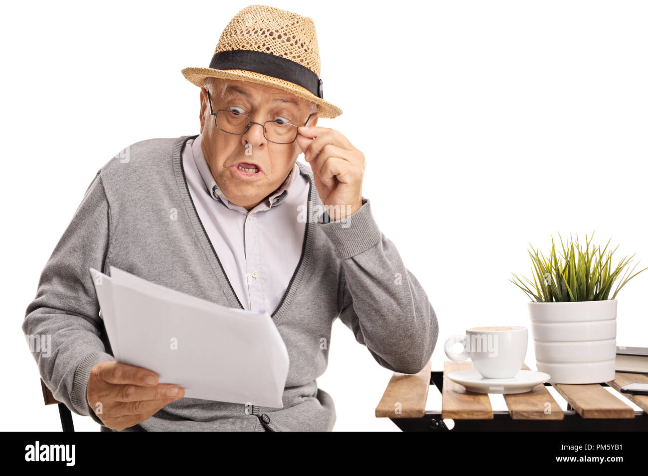 Shocked elderly man reading a document isolated on white background ...