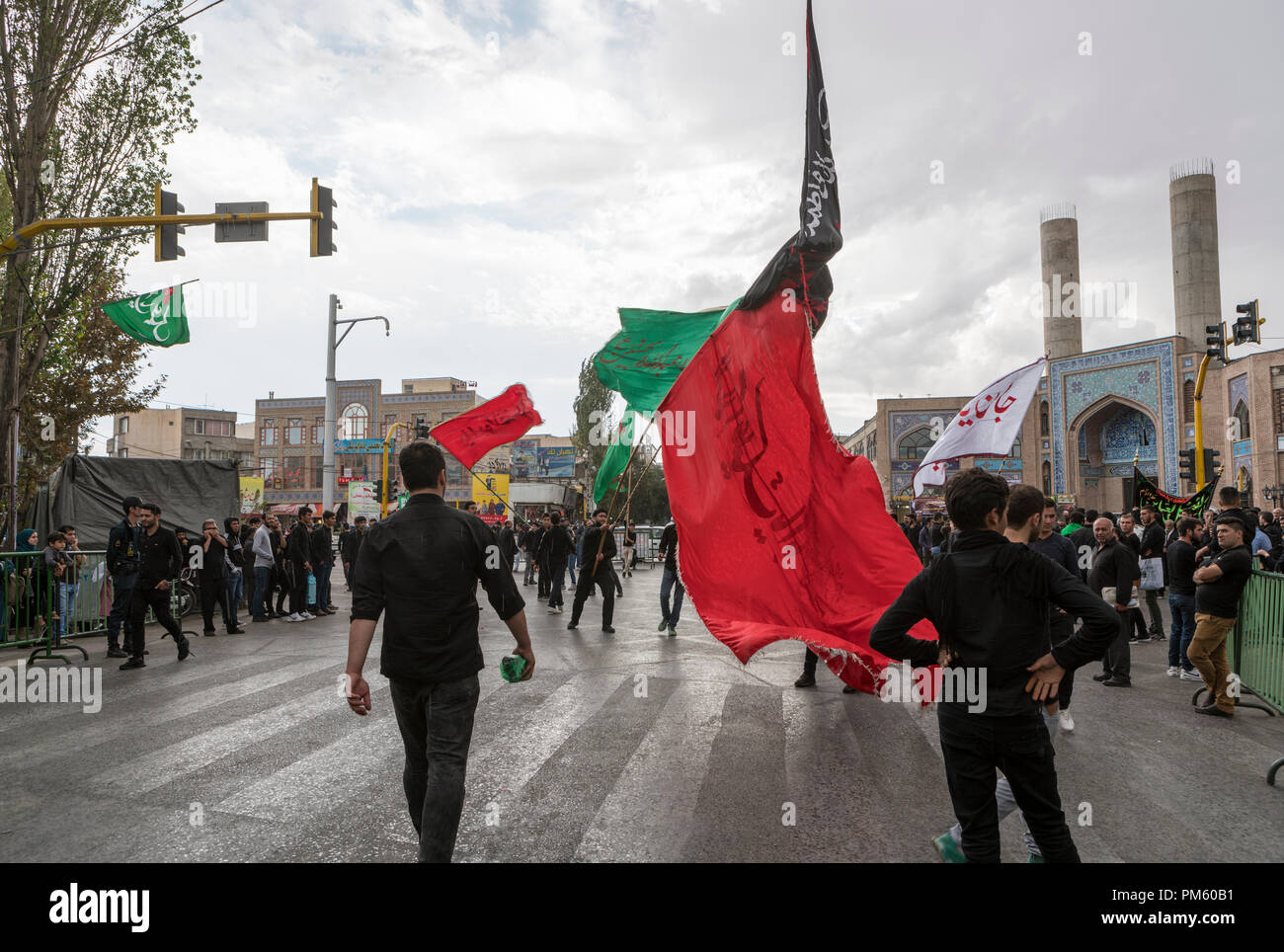 Young men waving flags during a public procession in the lead up to ...