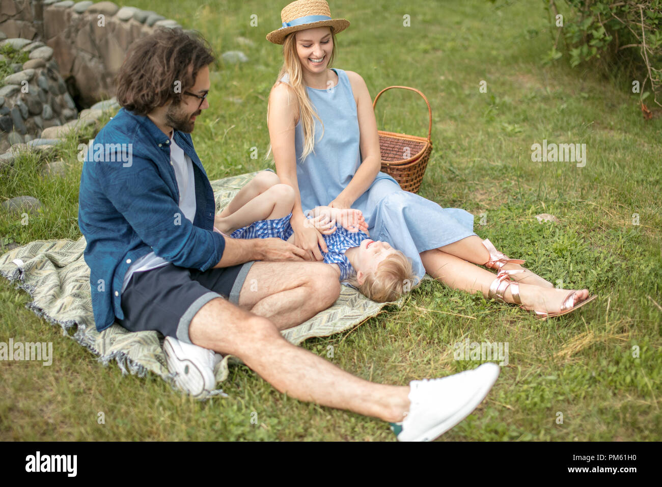 Family with child hugging and having fun outdoor Stock Photo - Alamy