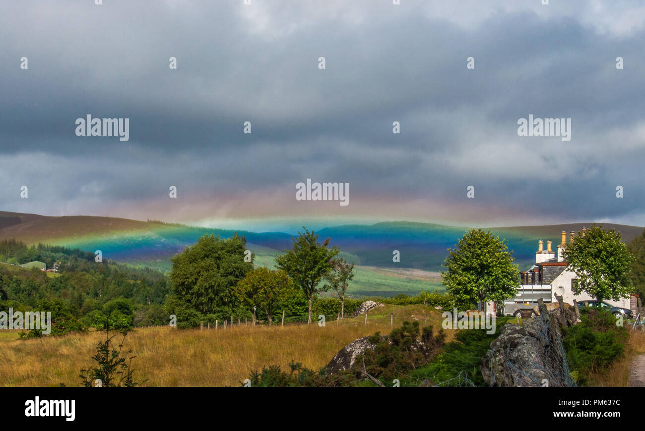 a low rainbow over scottish highlands Stock Photo - Alamy