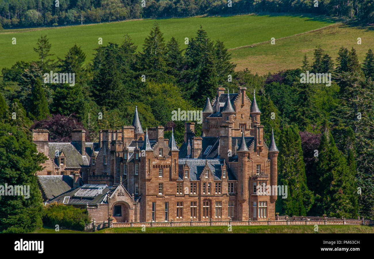 A castle against trees and a green field Stock Photo - Alamy