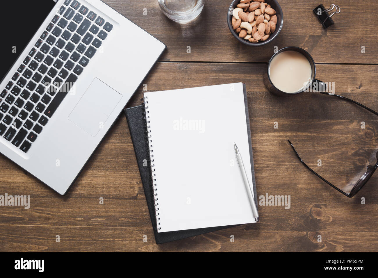 Workplace with open laptop, accessory on office table. Top view and ...