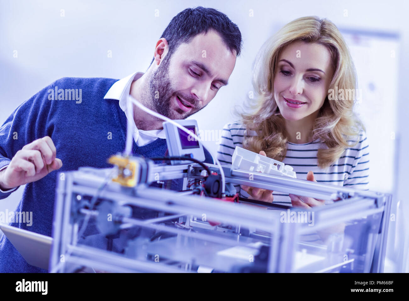 Positive delighted couple working together in laboratory Stock Photo ...