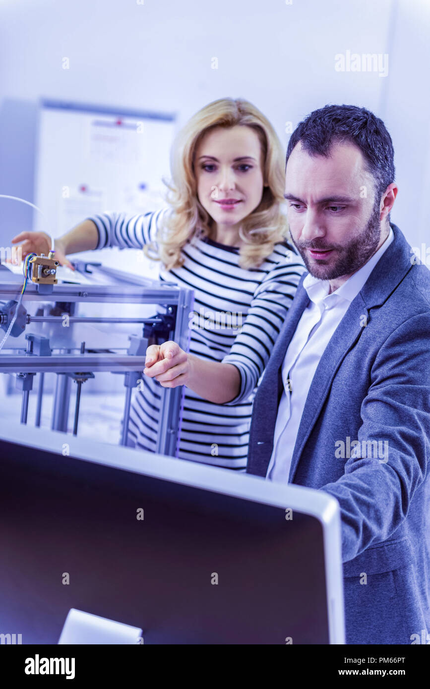 Concentrated young people watching modern video instruction Stock Photo ...