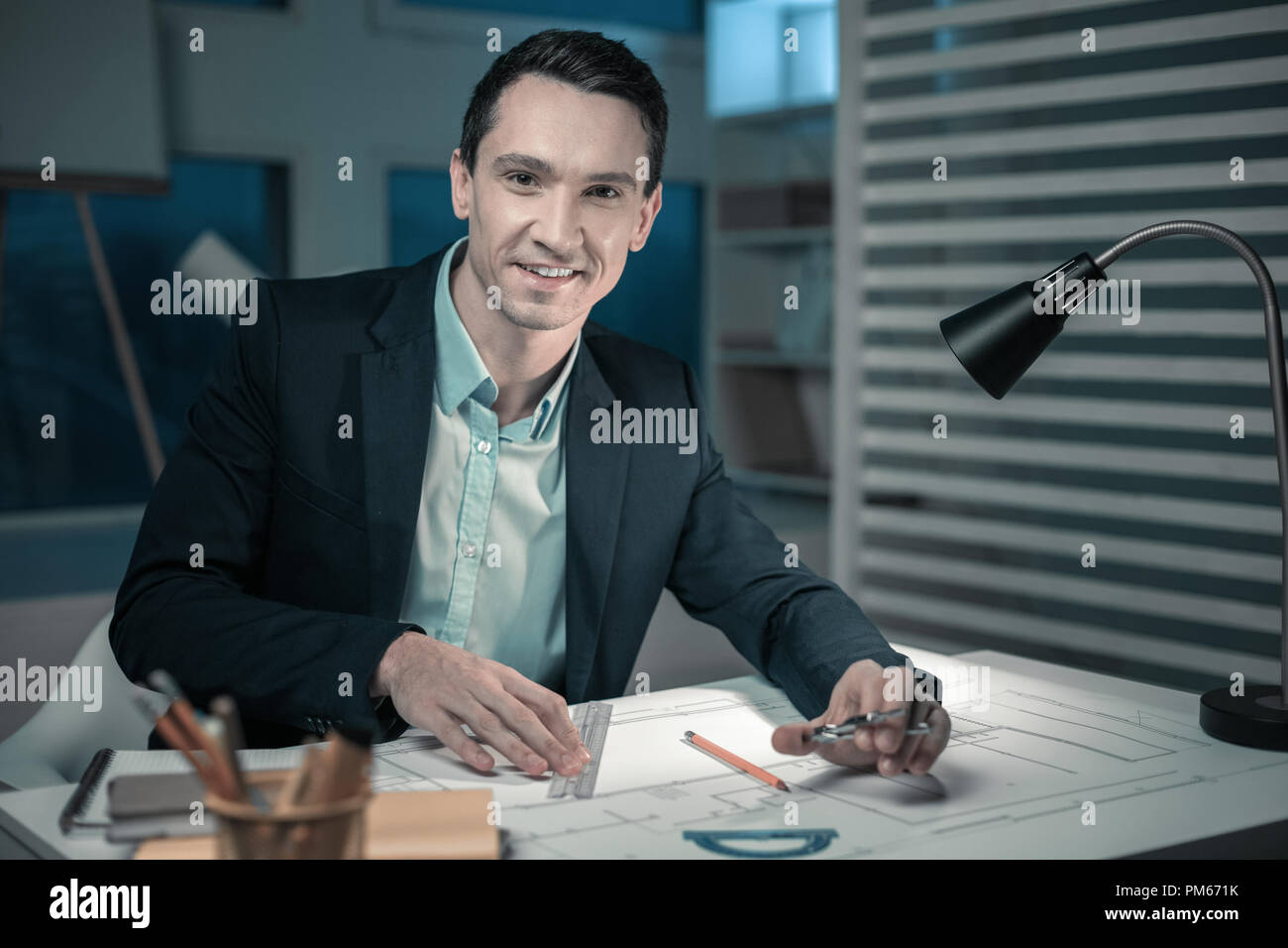 Smart engineer doing a blueprints at the office Stock Photo - Alamy