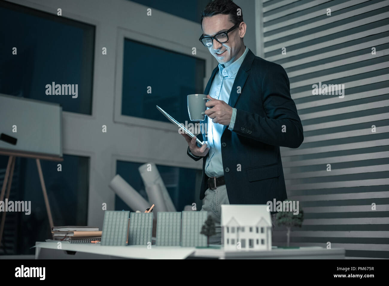 Smart man drinking a coffee at the office Stock Photo - Alamy