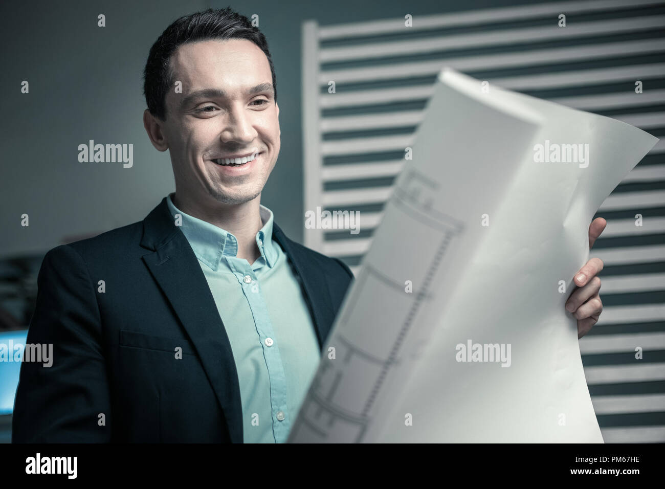 Cheerful leader approving professional drawings of his employee Stock ...