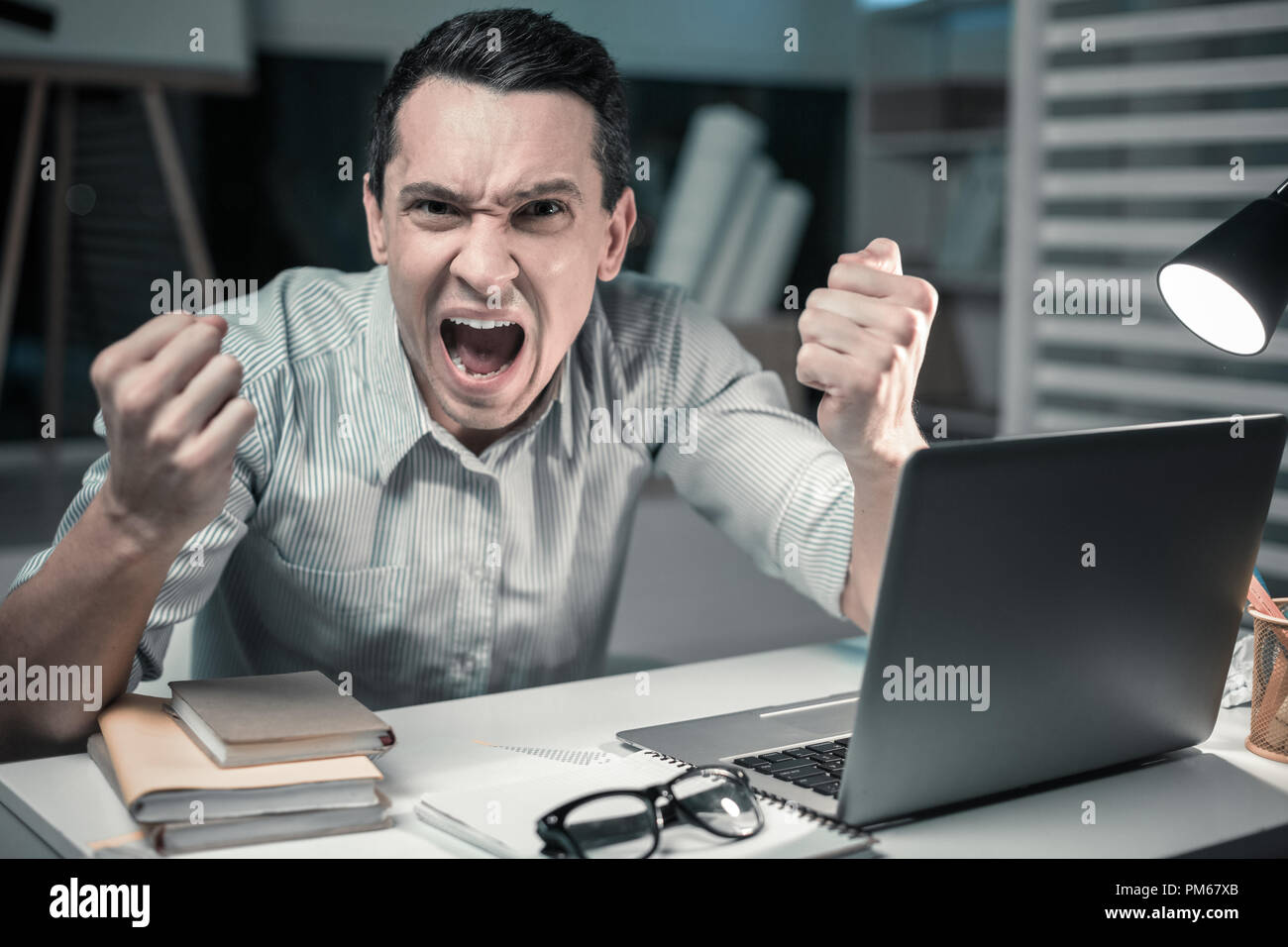 Furious man clenching his fists screaming something Stock Photo - Alamy