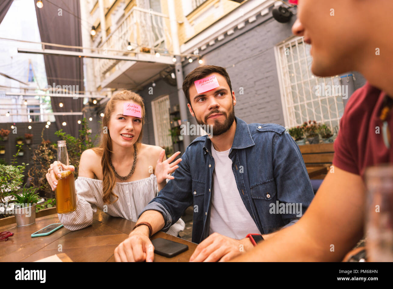 Two people looking thoughtful while explaining the word in the game ...
