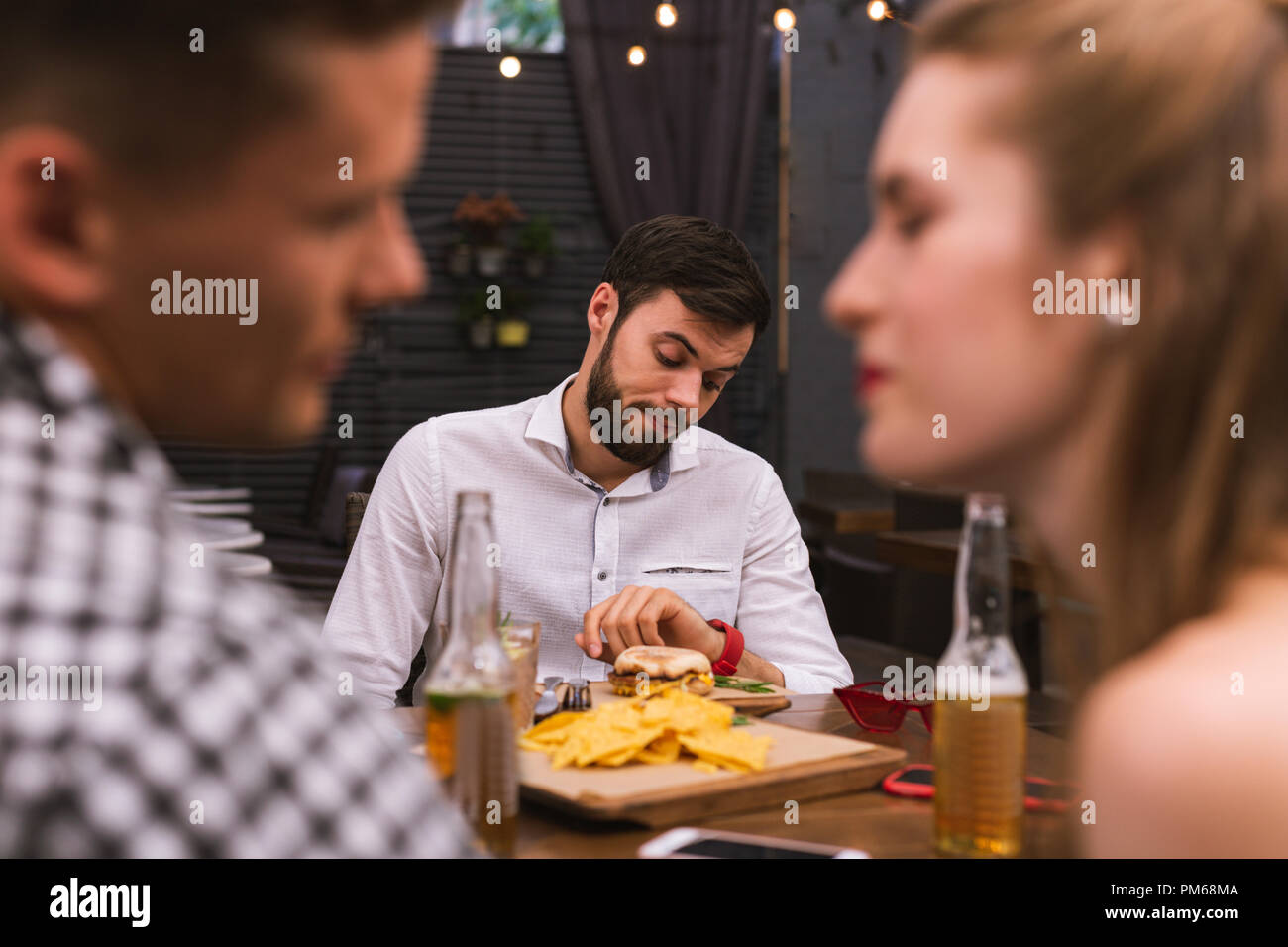 Young man looking at the watch while feeling bored at the meeting Stock ...
