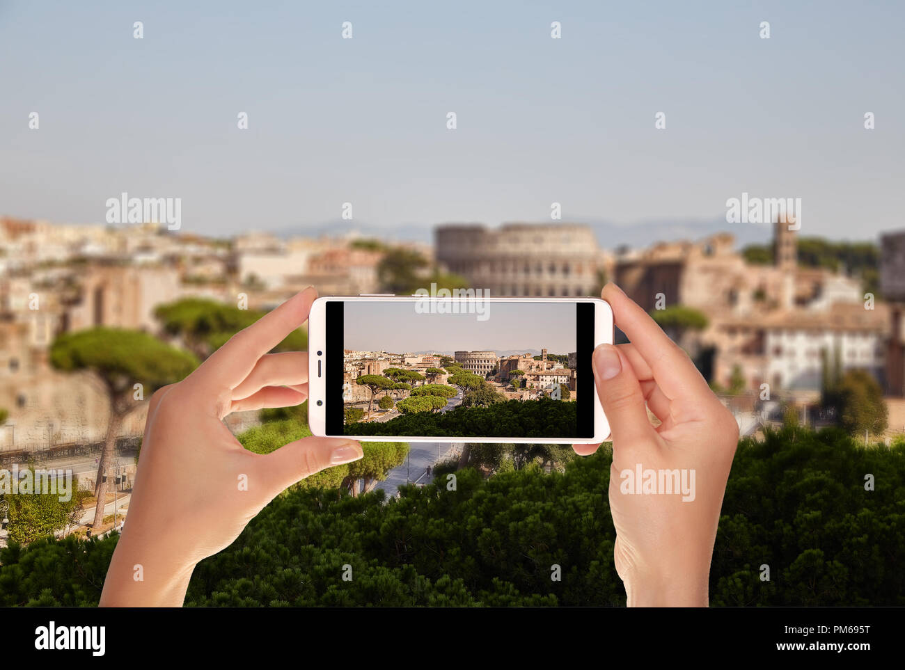A tourist is taking a photo of Rome cityscape with beautiful ancient ...