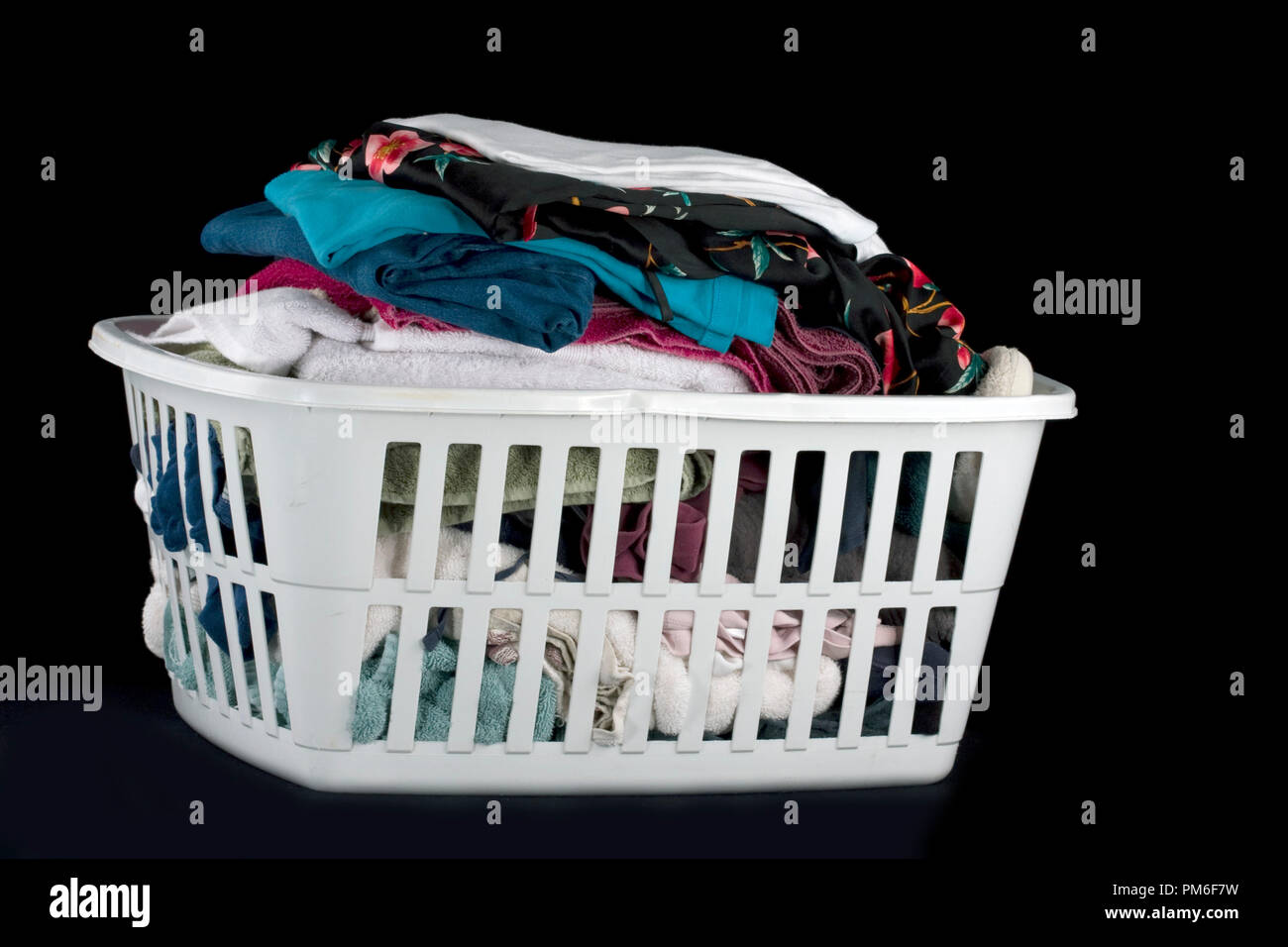 White laundry basket filled with folded clothes after wash Stock Photo ...