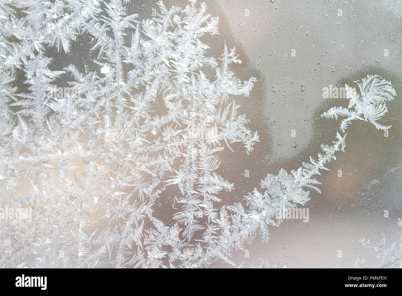 Beautiful ice formations on panes of glass in window Stock Photo - Alamy