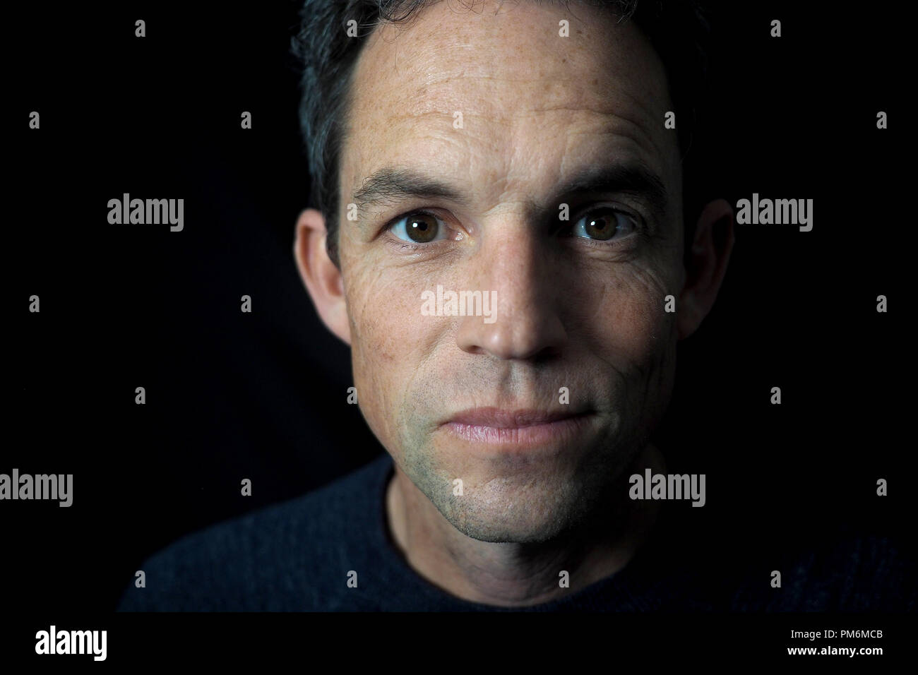 Portrait of man on black background Stock Photo - Alamy