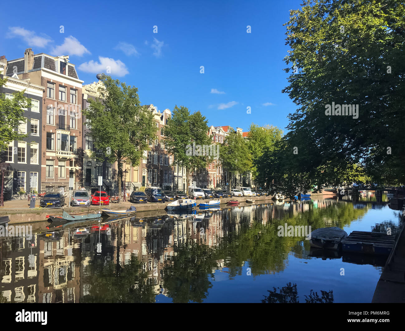 Canal and buildings in Amsterdam, Netherlands on a sunny summer ...