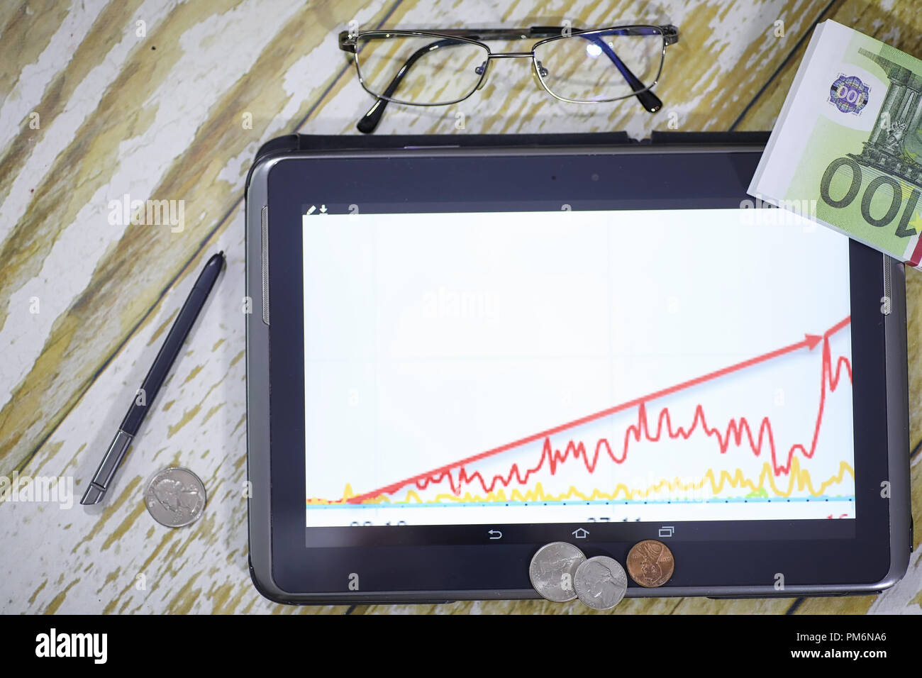 The graph of income growth. Electronic tablet with a graph of gr Stock ...